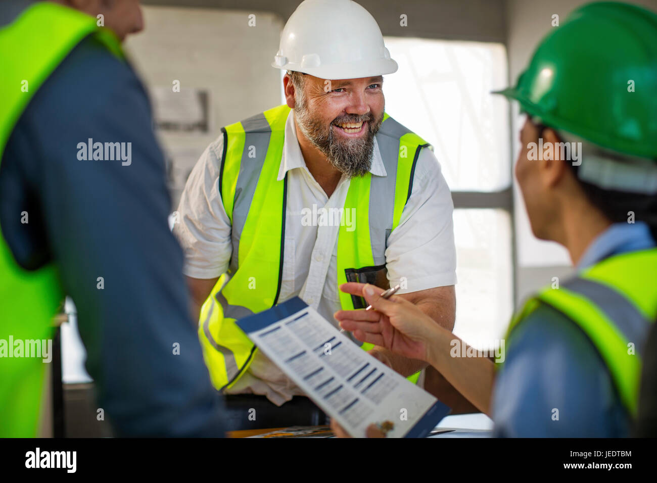 Workers discussing at site office Stock Photo - Alamy