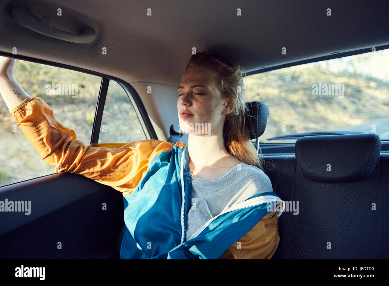 Young woman relaxing in a car Stock Photo - Alamy