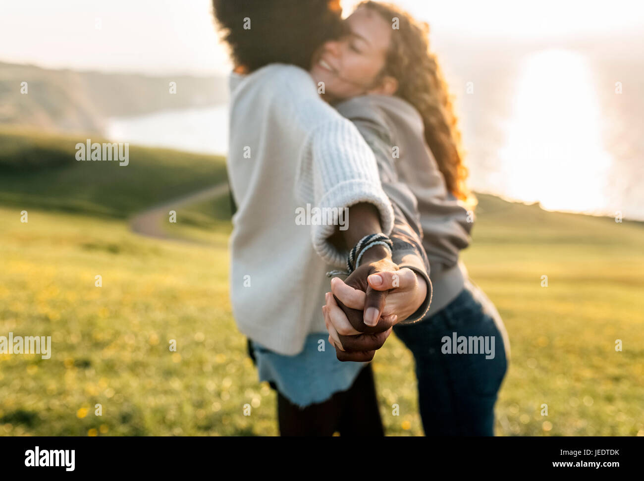 Two best friends holding hands outdoors Stock Photo - Alamy