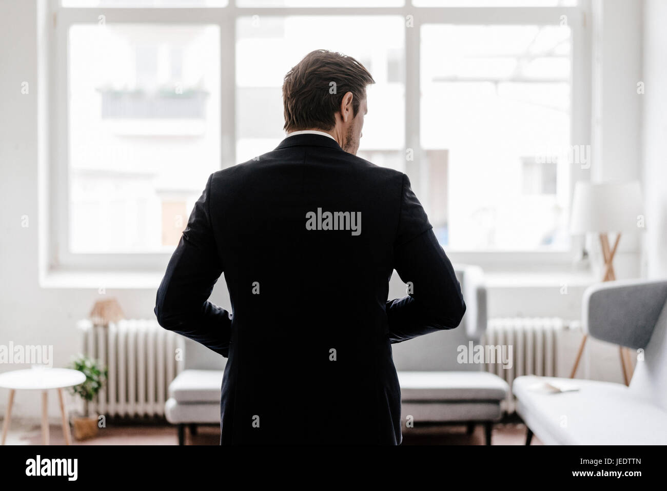 Rear view of businessman in office Stock Photo - Alamy