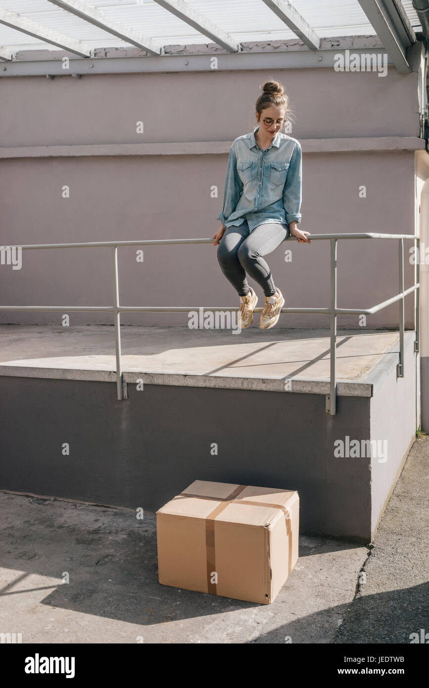 Young woman about to jump on cardboard box Stock Photo - Alamy