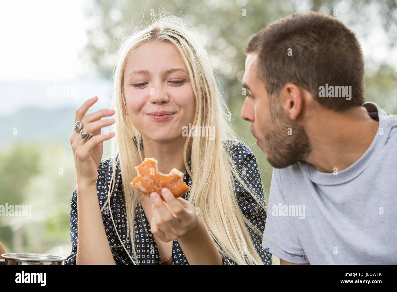 Portrait of woman eating pastry Stock Photo - Alamy