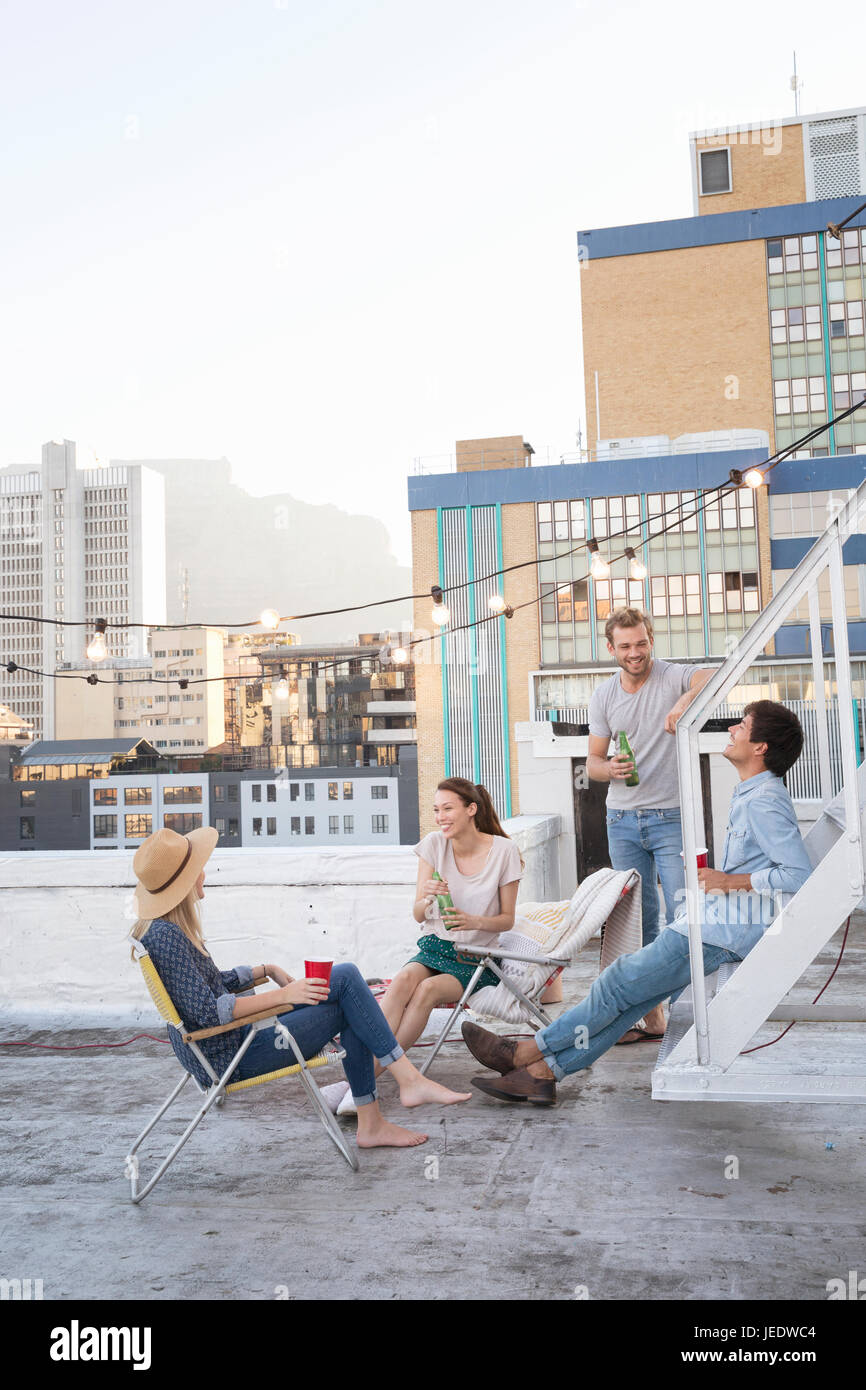 Friends having a rooftop party on a beautiful summer evening Stock ...