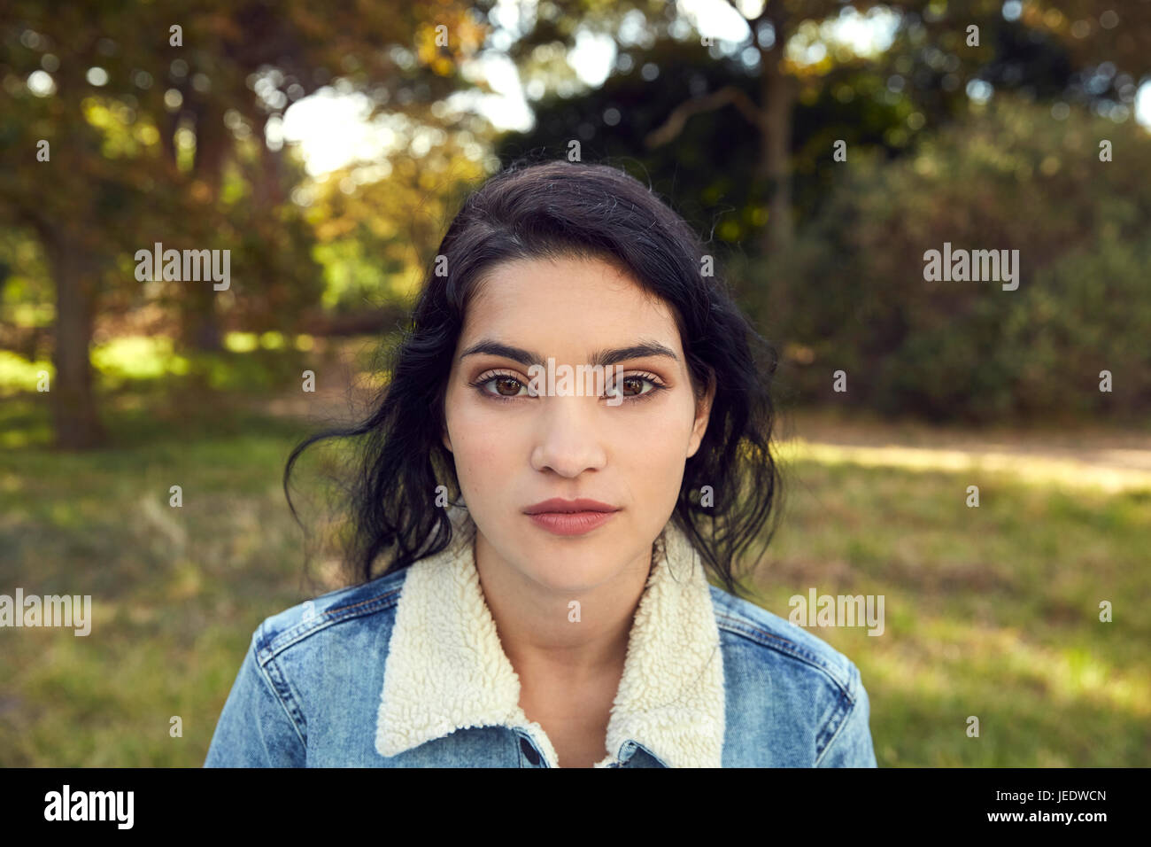 Portrait of dark-haired young woman in nature Stock Photo - Alamy