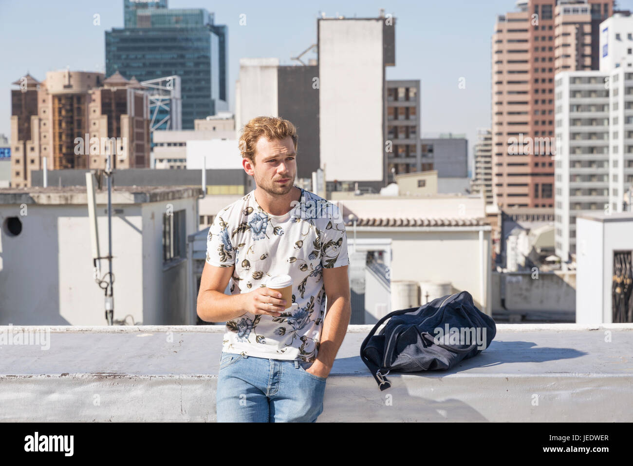 Man standing on roof three hi-res stock photography and images - Alamy