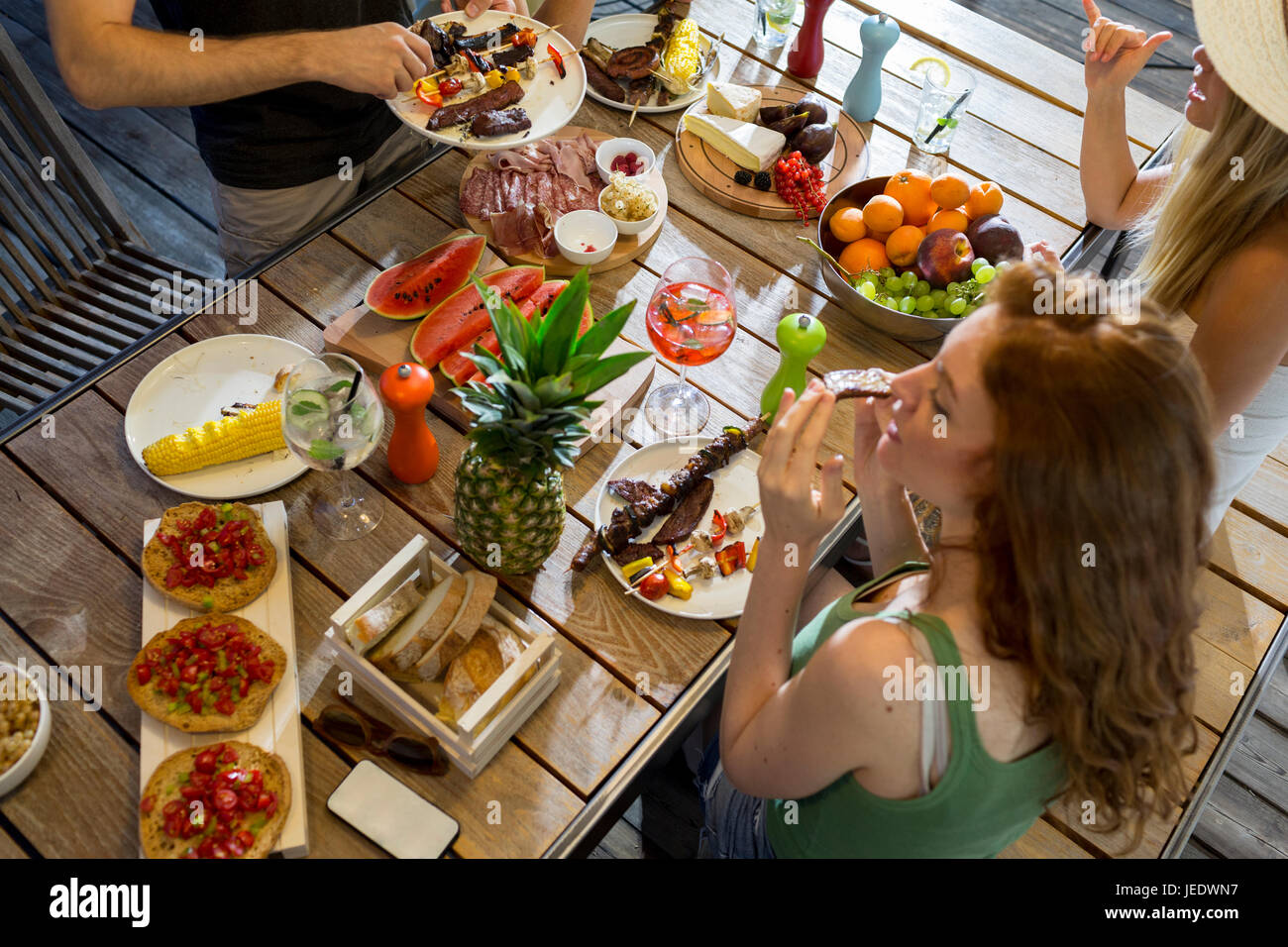 Friends having dinner at outdoor table Stock Photo - Alamy