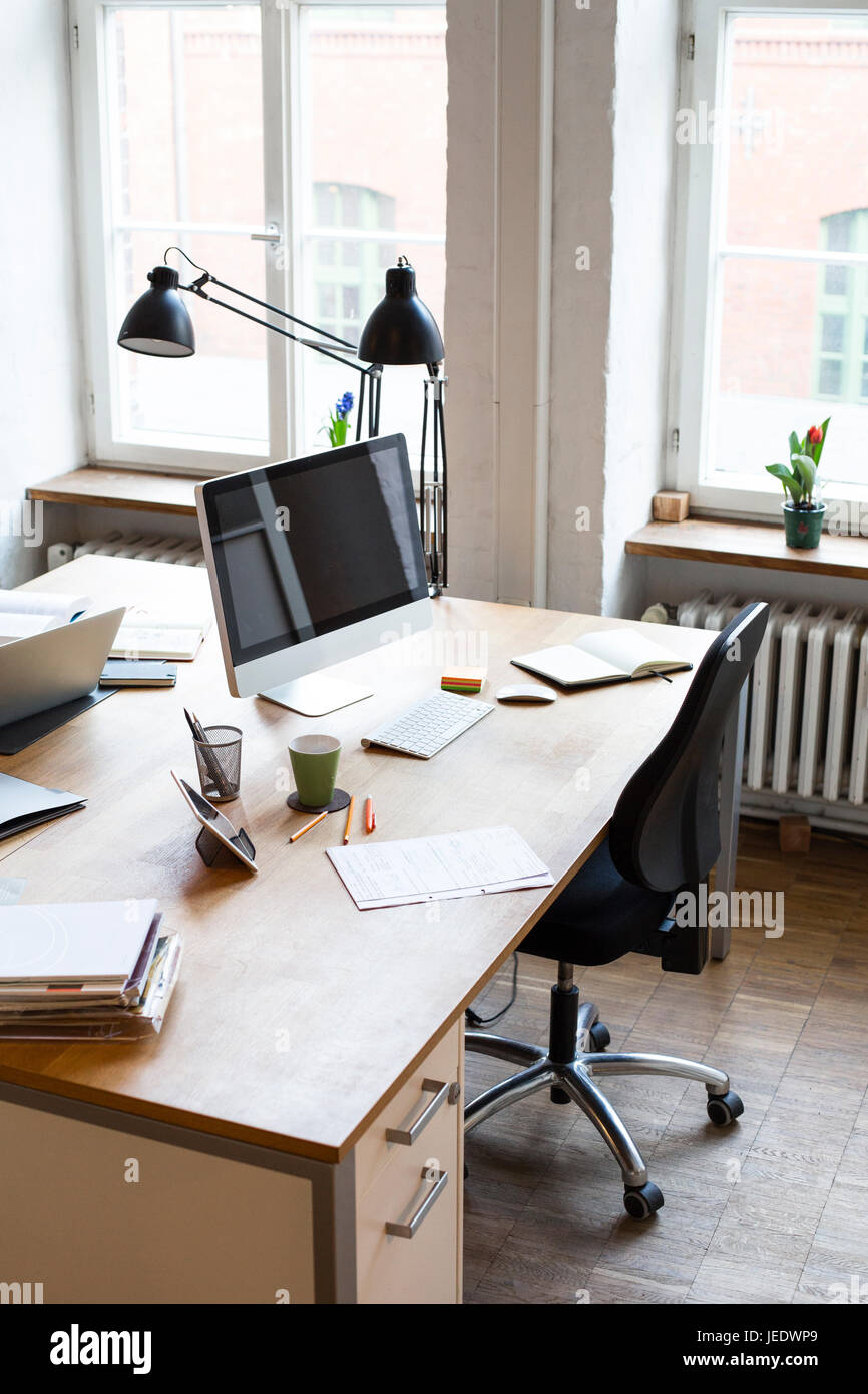 Desk with documents and computer screen Stock Photo - Alamy