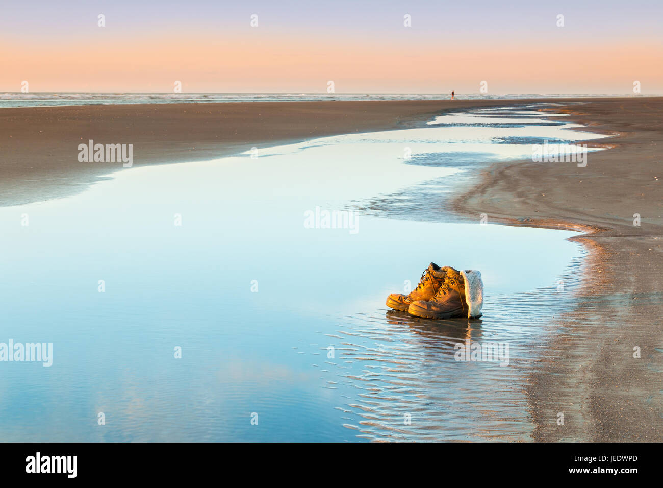 A pair of work boots by a pool of sea water Stock Photo - Alamy