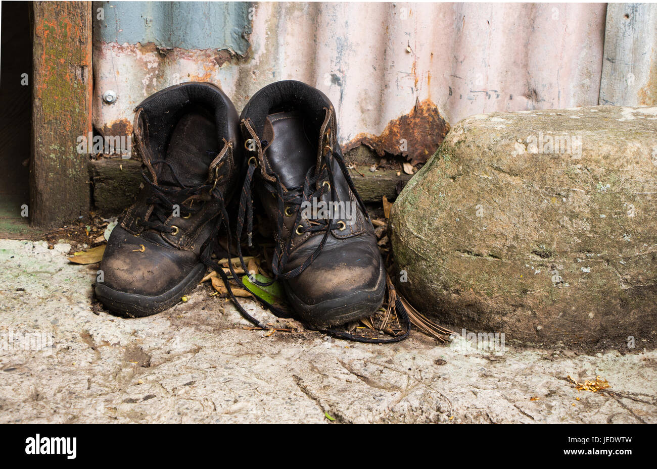 A pair of work boots parked out side a door way Stock Photo - Alamy