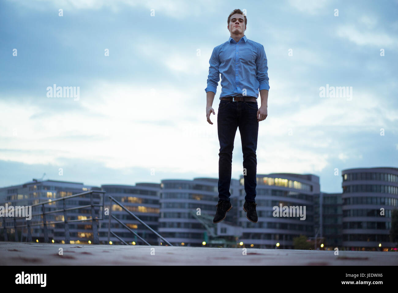 Portrait of young man jumping in the air Stock Photo - Alamy