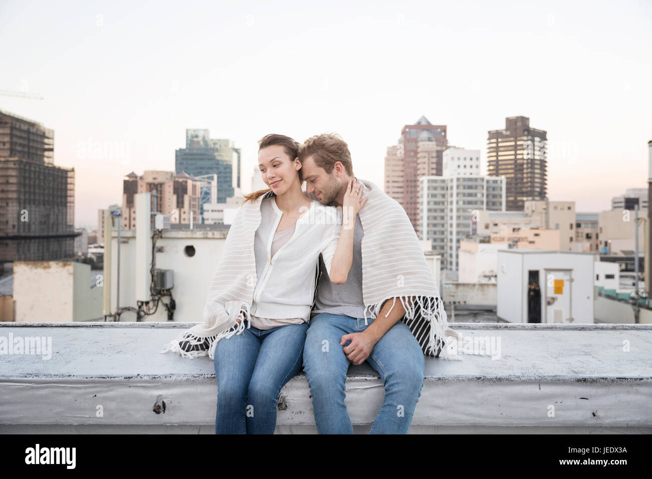Romantic couple sitting on rooftop hi-res stock photography and images ...