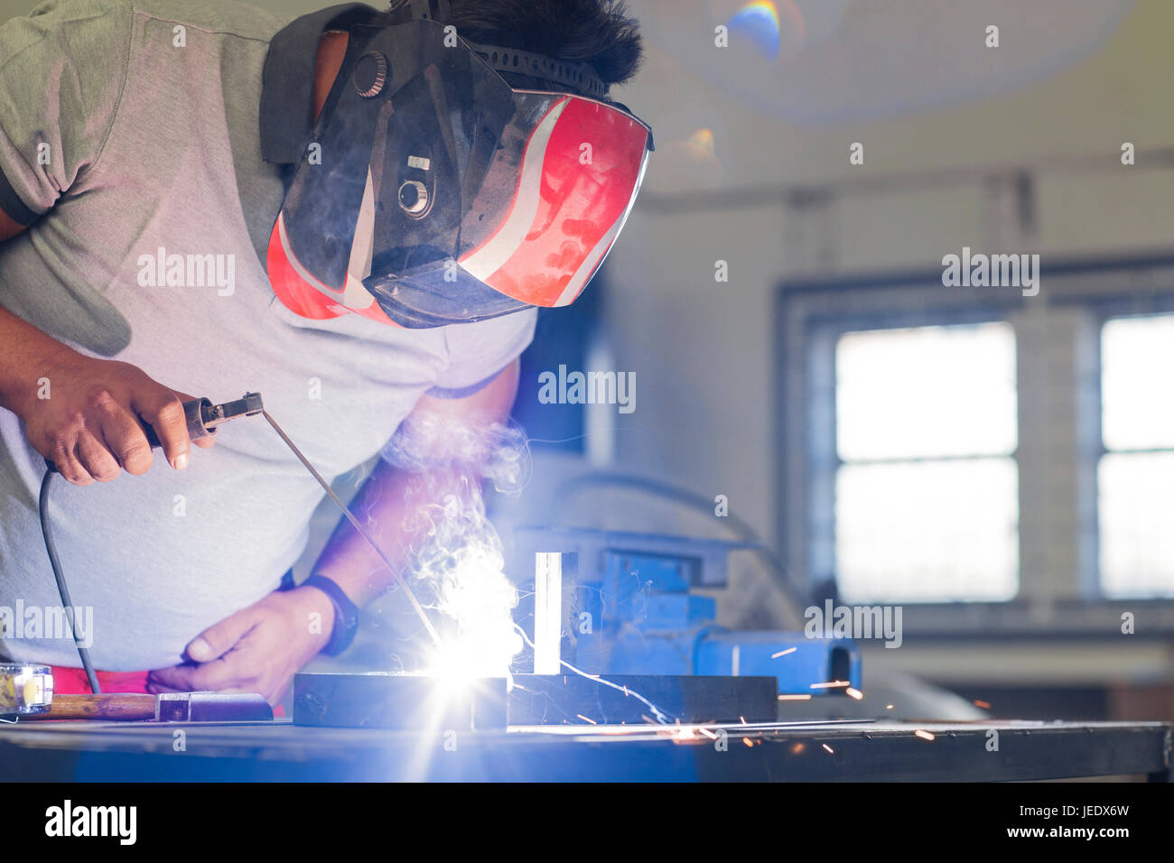 Mechanic welding in car workshop Stock Photo - Alamy