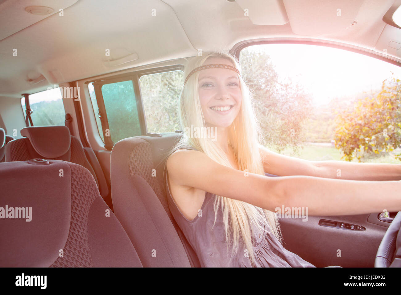 Happy young woman driving car Stock Photo - Alamy
