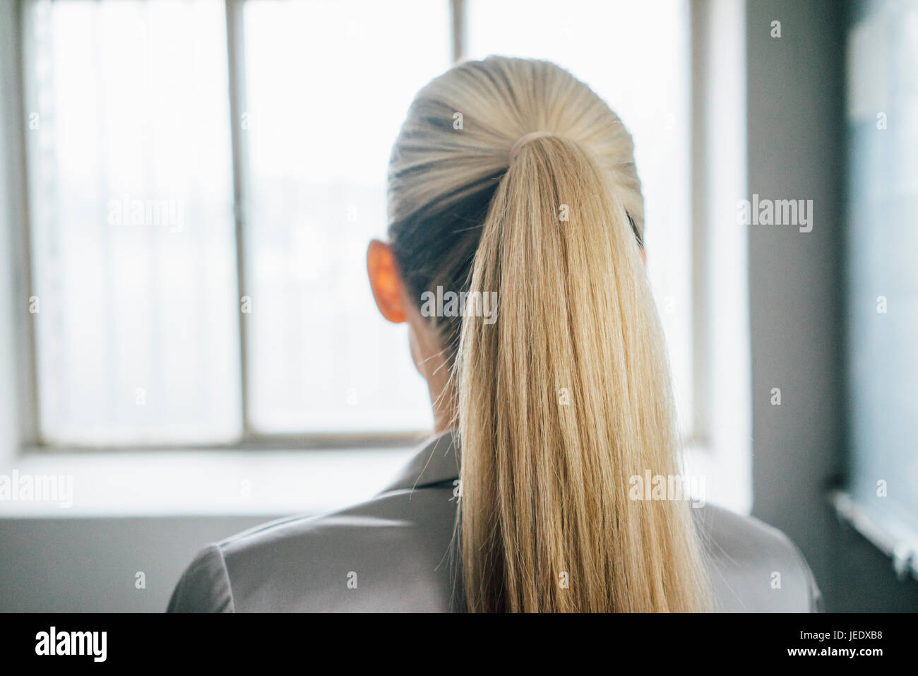 Back view of blond woman with ponytail Stock Photo - Alamy