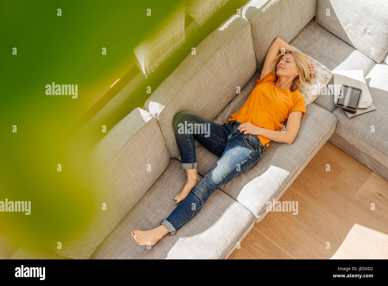 Person lying on couch hi-res stock photography and images - Alamy