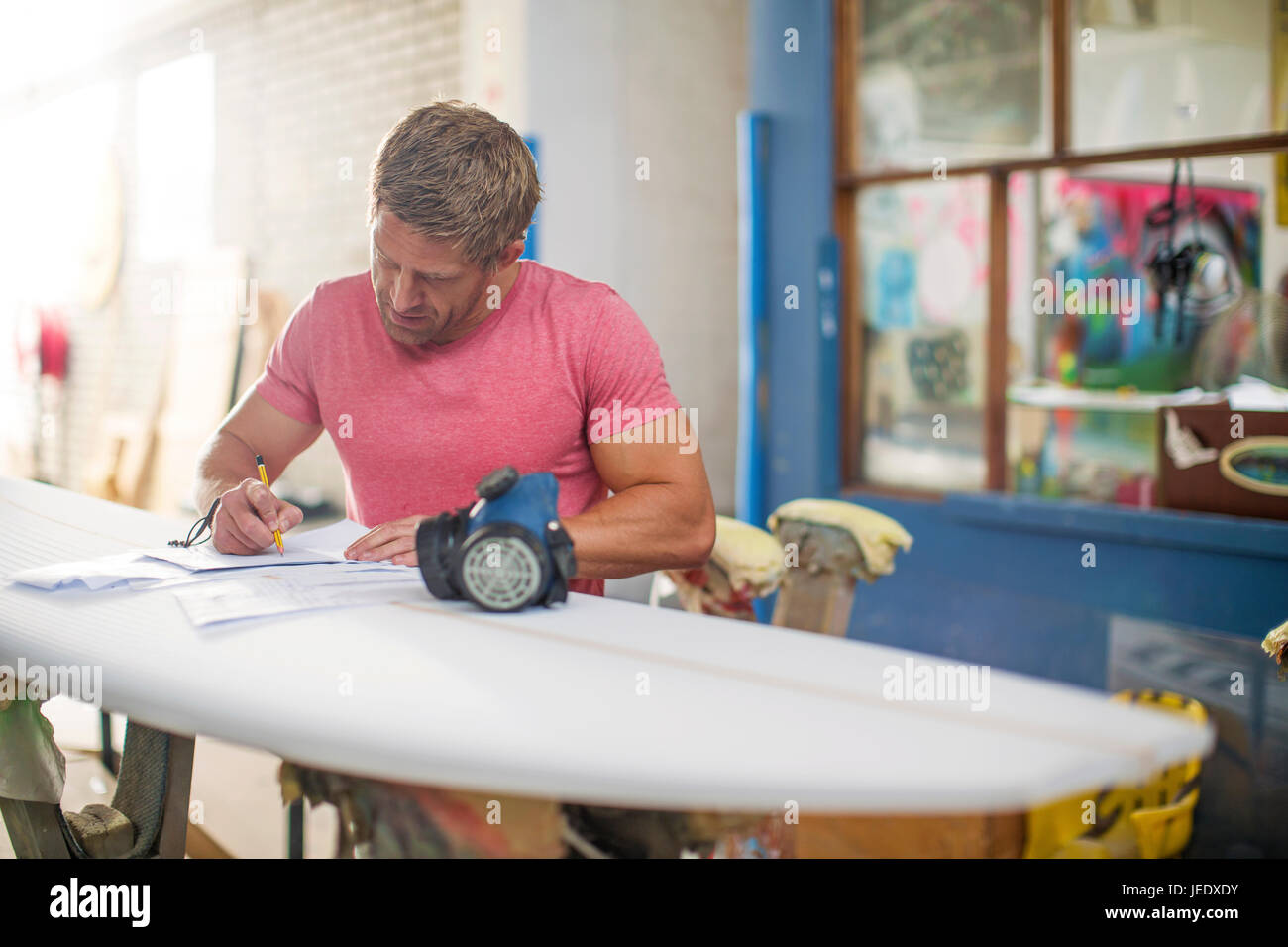 Surfshop employee filling out paper work hi-res stock photography and ...