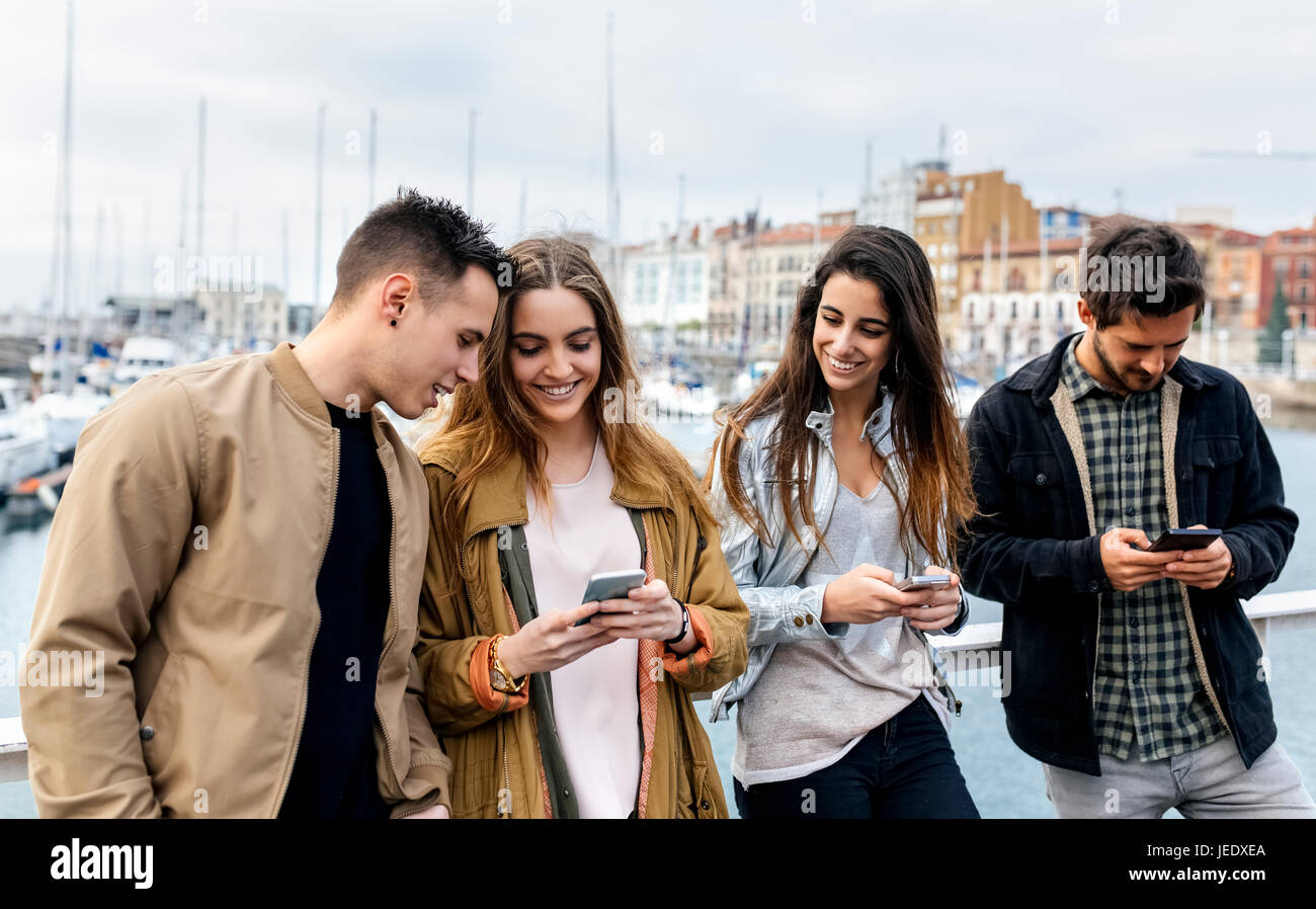 Group of friends sending messages with the smartphone Stock Photo - Alamy