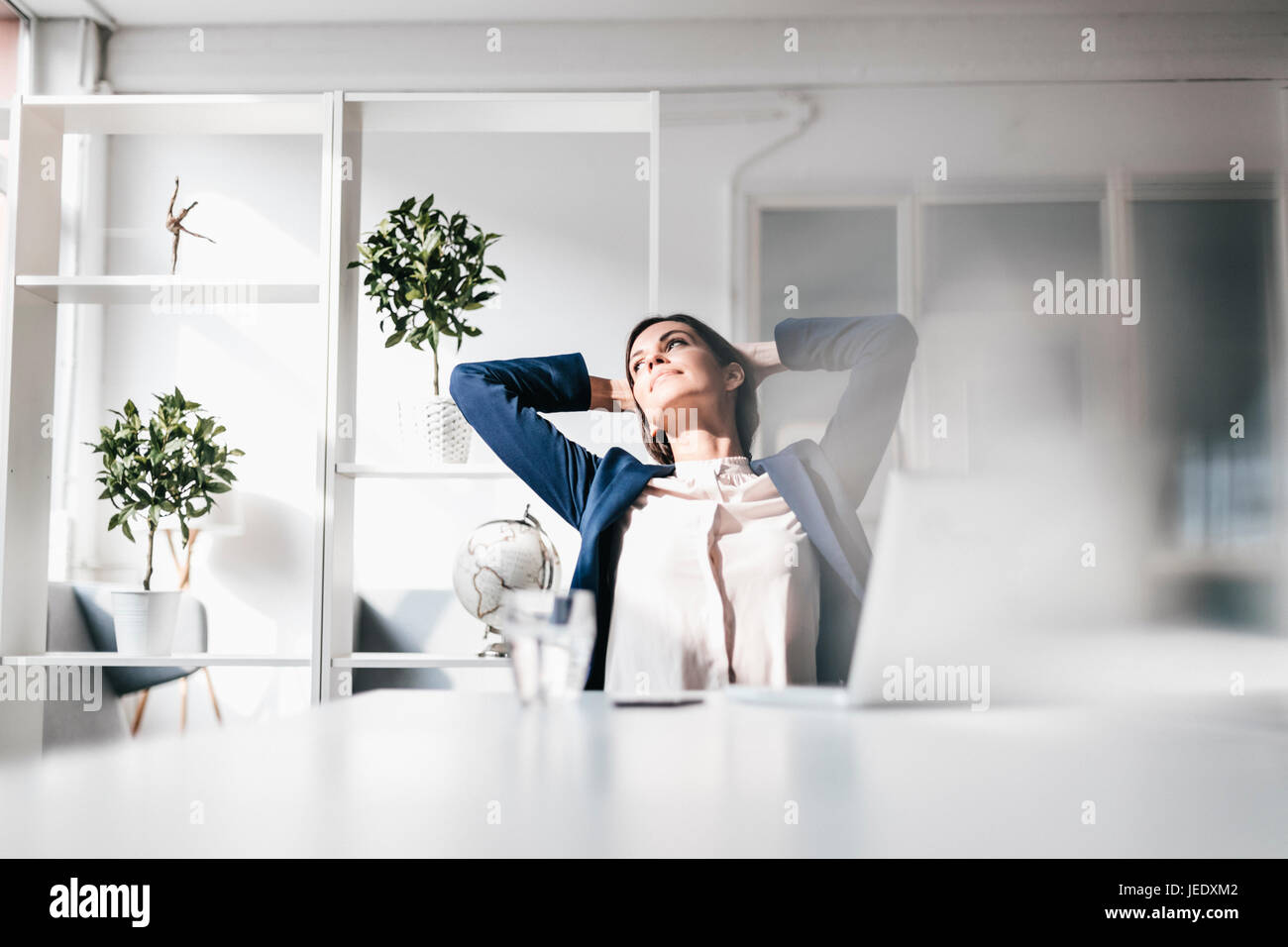 Woman leaning back desk hands hi-res stock photography and images - Alamy