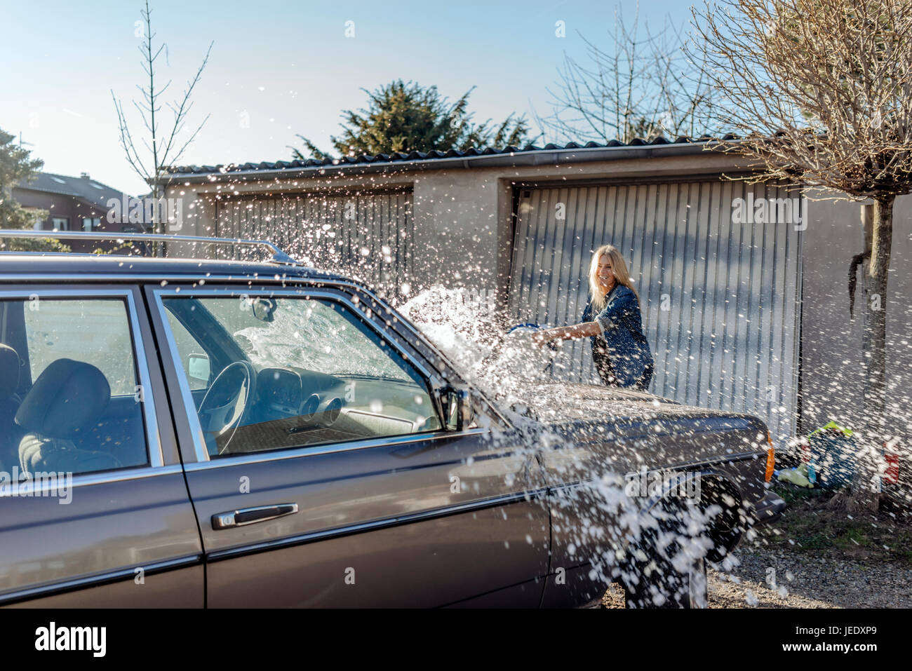 Woman washing her car Stock Photo - Alamy
