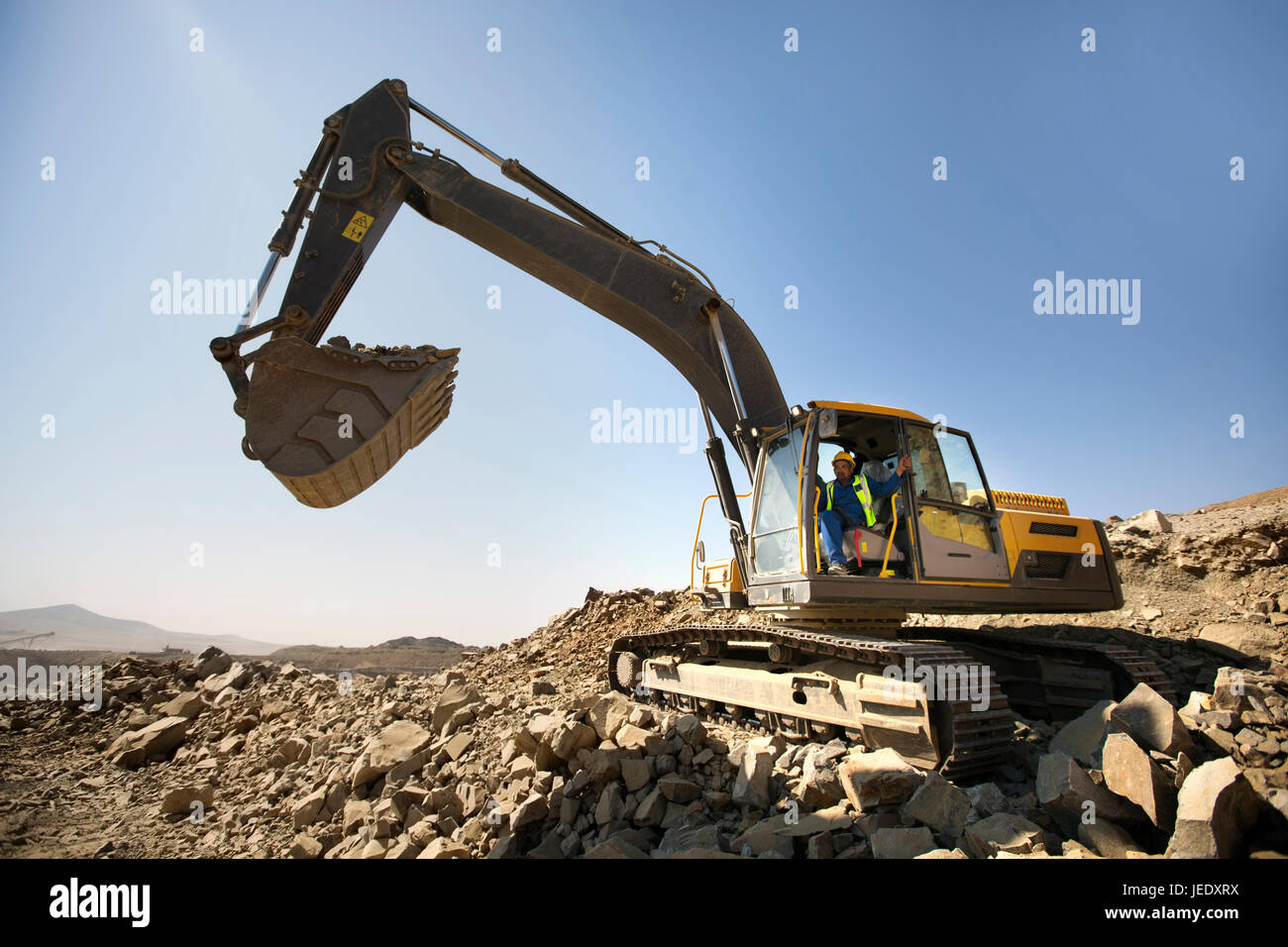 Digger working in quarry Stock Photo - Alamy