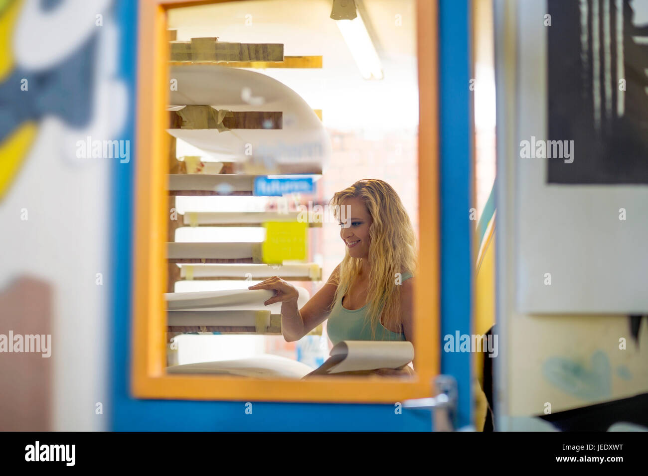 Surfboard shaper workshop, surfshop employee selecting a surfboard ...
