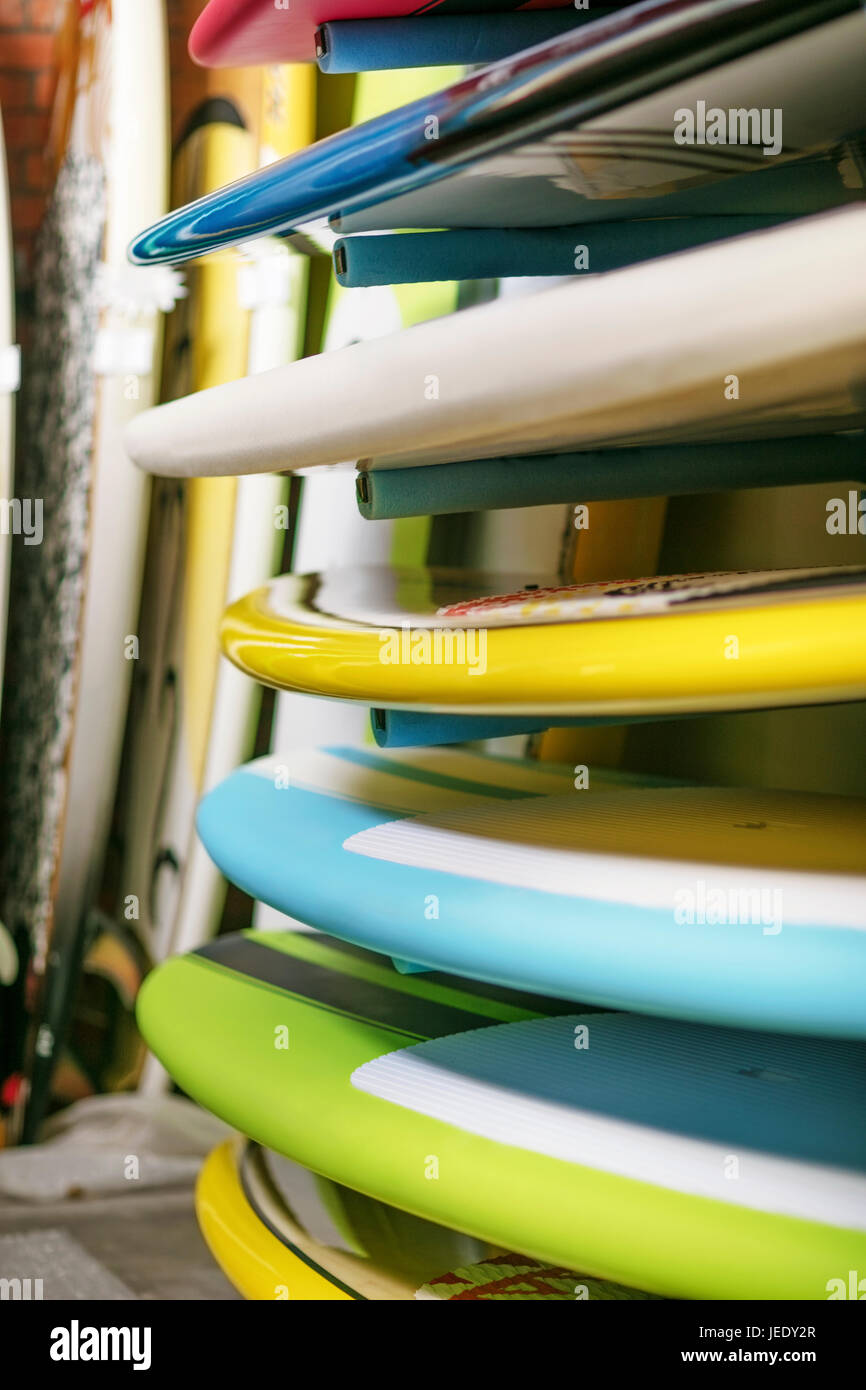 Stacked surfboards in surfshop Stock Photo - Alamy
