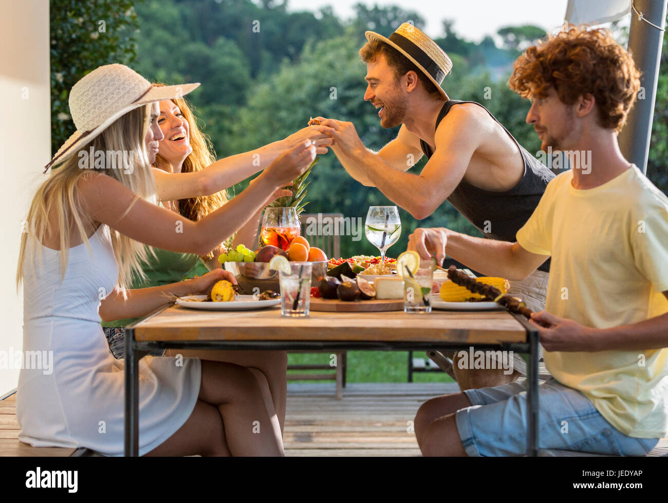 Happy friends having dinner at outdoor table Stock Photo - Alamy