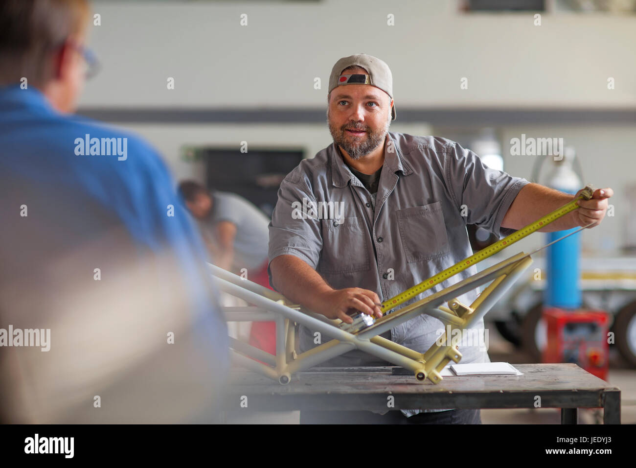 Mechanic measuring car unit in workshop Stock Photo - Alamy