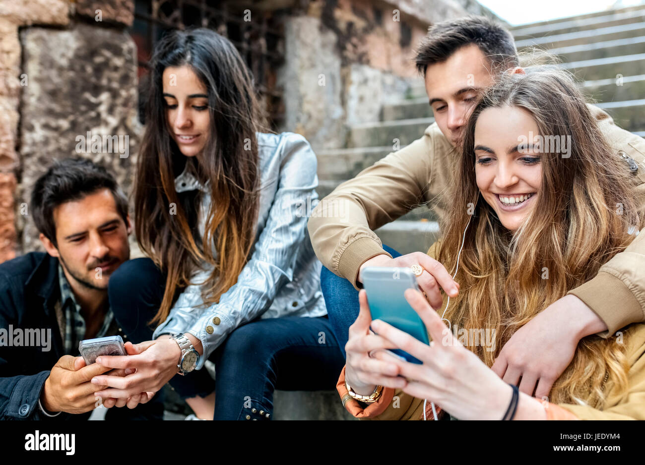 Group of friends sending messages with the smartphone Stock Photo - Alamy