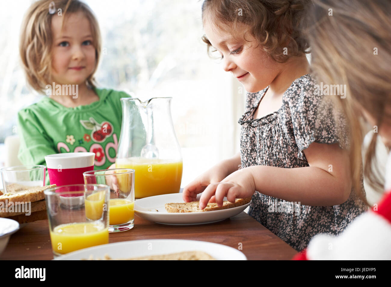 Little children at breakfast table Stock Photo - Alamy
