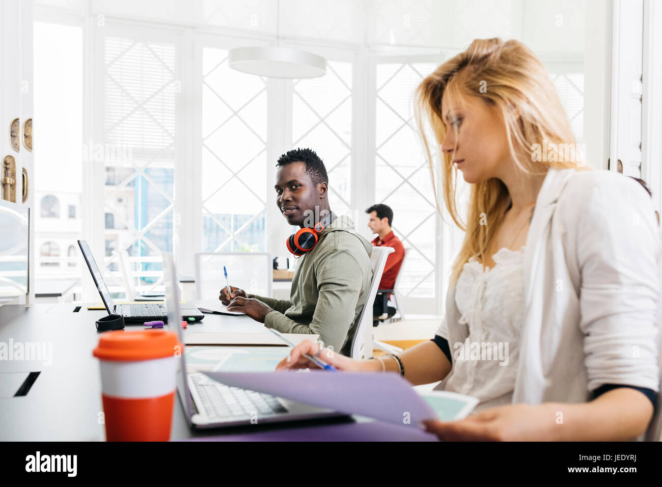 Business people working together in international office Stock Photo ...
