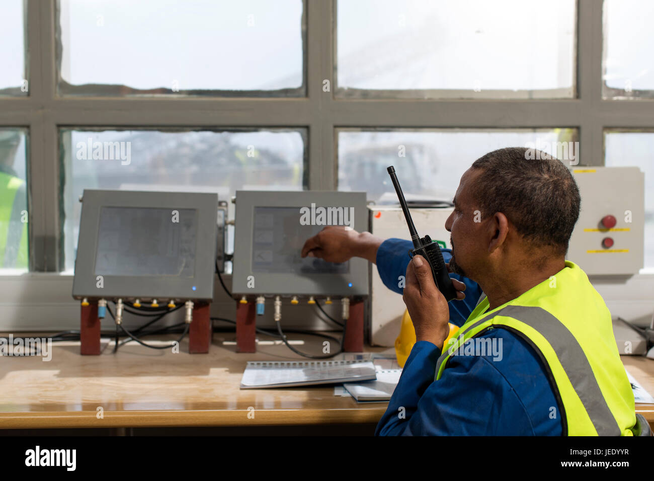 Worker at site office talking at radio device Stock Photo - Alamy