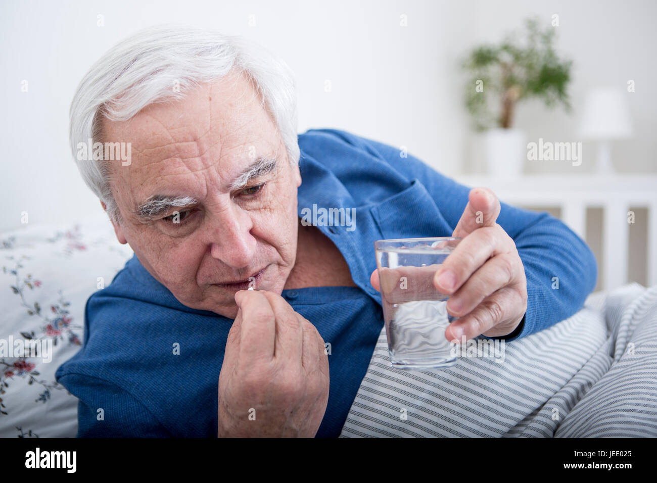 Sick man taking tablets Stock Photo - Alamy