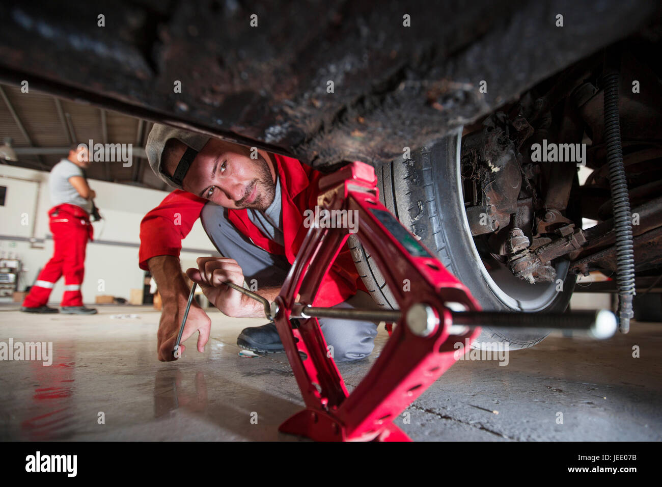 Mechanics repairing car in workshop Stock Photo - Alamy