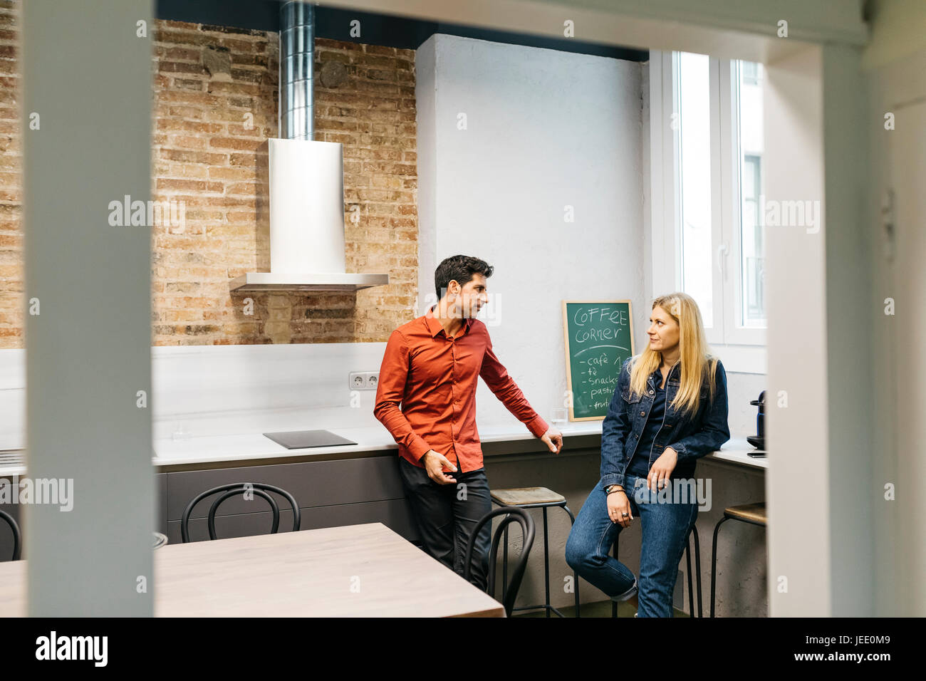 Colleagues talking in office kitchen Stock Photo - Alamy