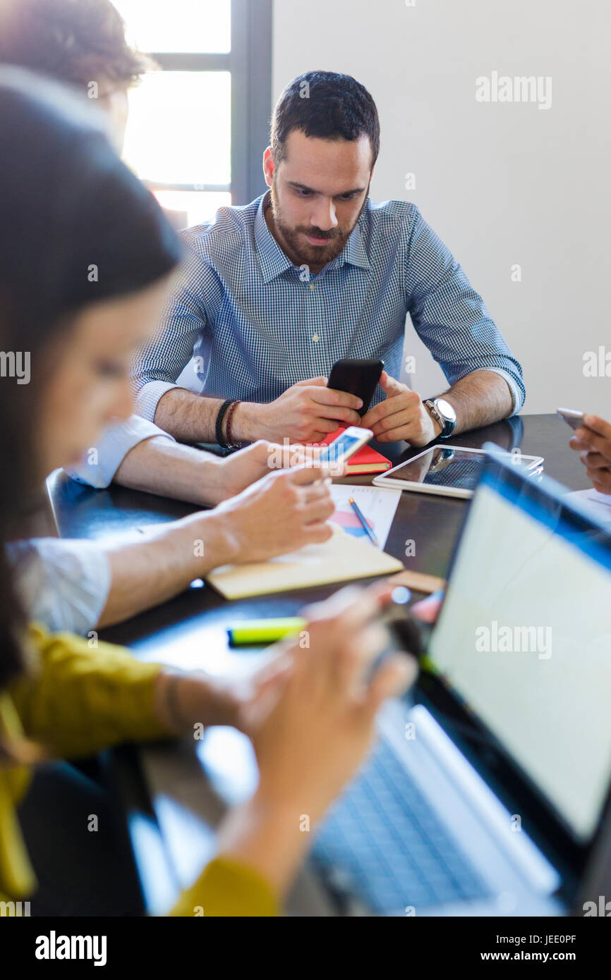 Business people using cell phones during a meeting in office Stock ...