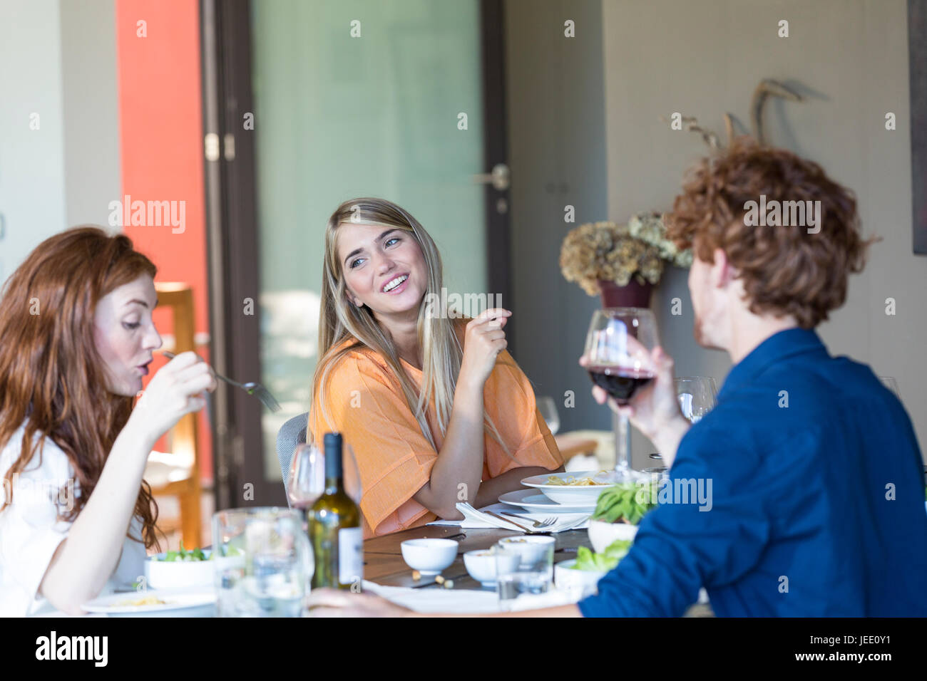 Friends eating together spaghetti carbonara Stock Photo - Alamy