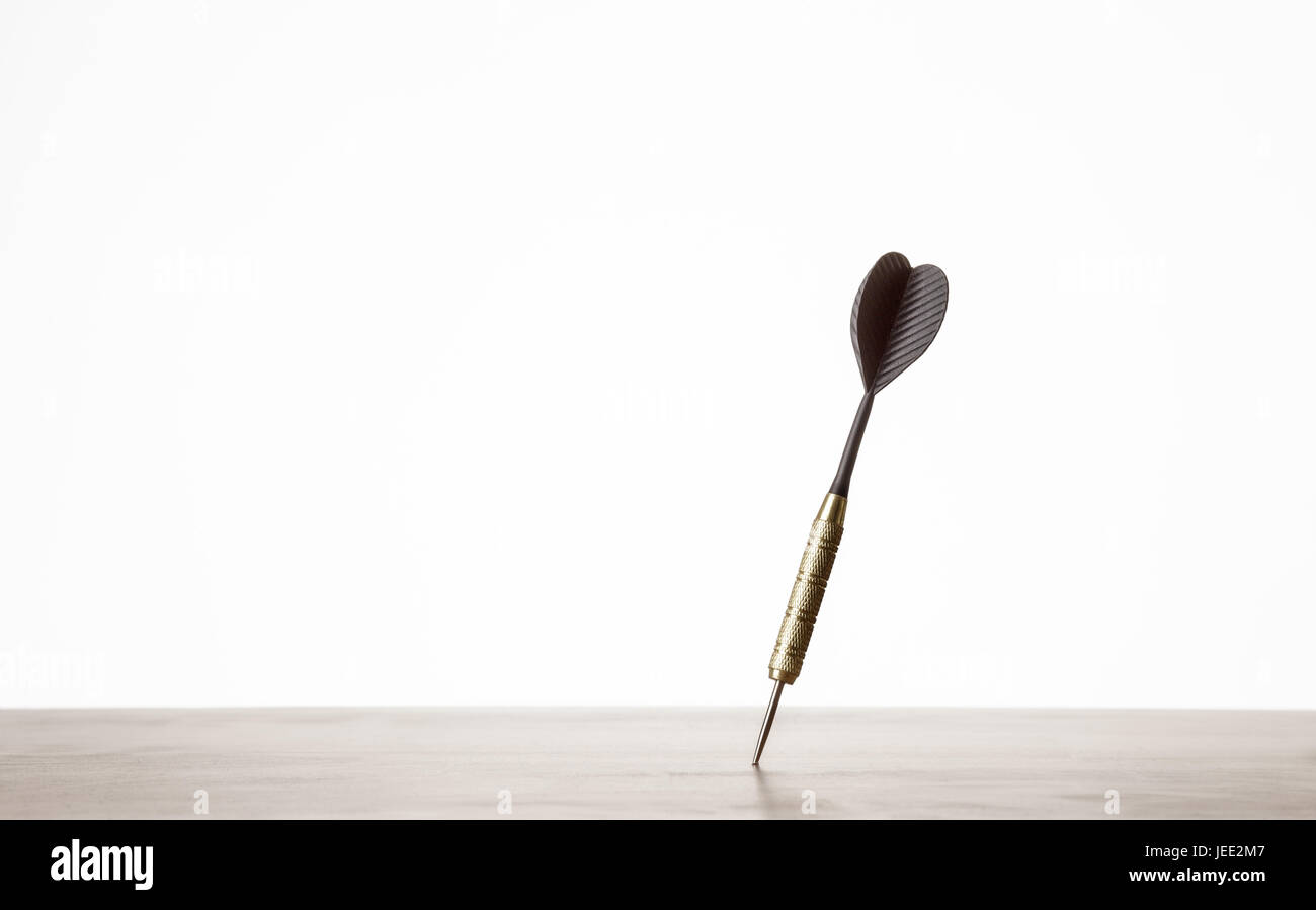 single playing dart in wooden table top Stock Photo - Alamy
