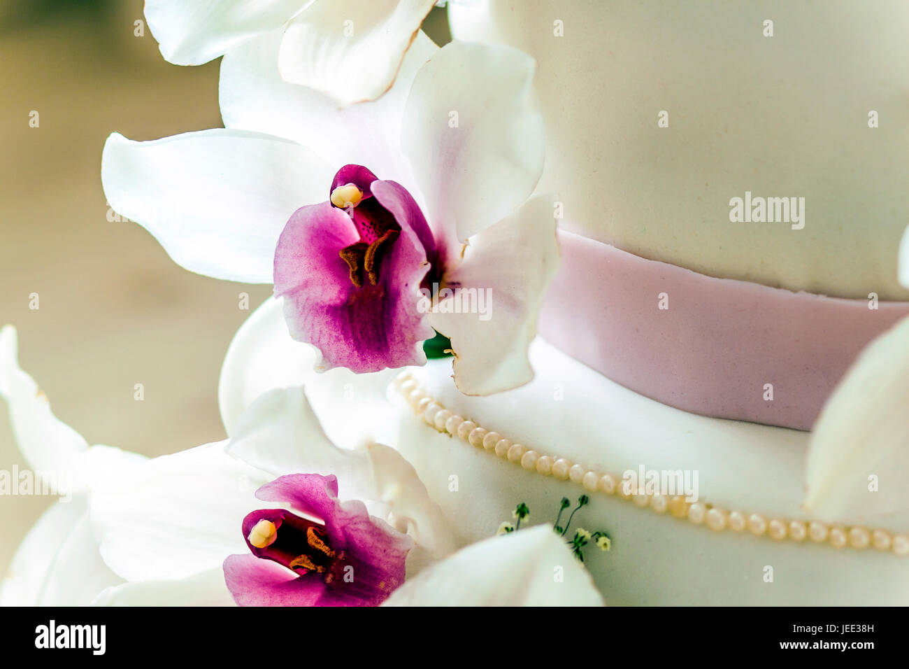 Beautiful wedding cake with flowers, close up of cake with blurred ...
