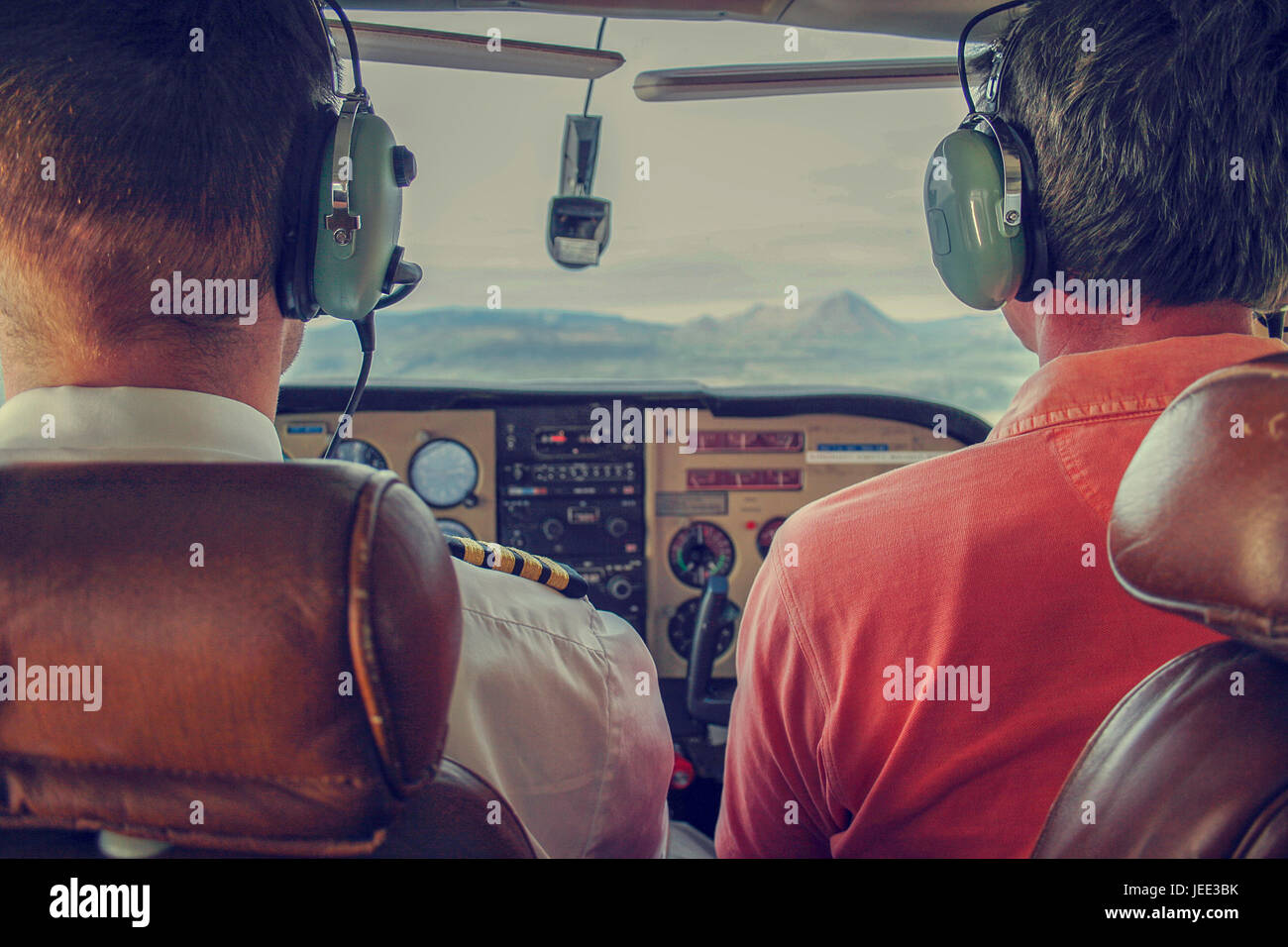 Two men in cockpit of small plane Stock Photo - Alamy