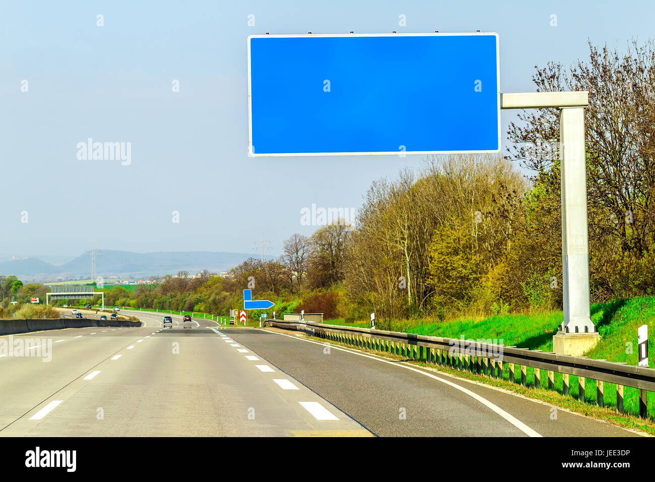 Blank blue freeway sign over the road on sunny day Stock Photo - Alamy