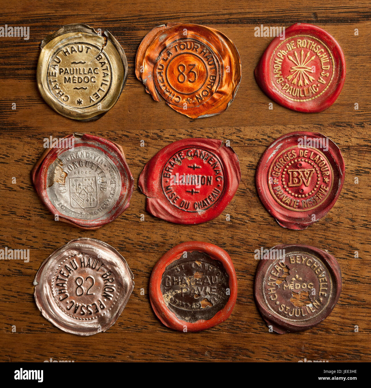 Bordeau wine caps in a grid layout on wooden board Stock Photo - Alamy