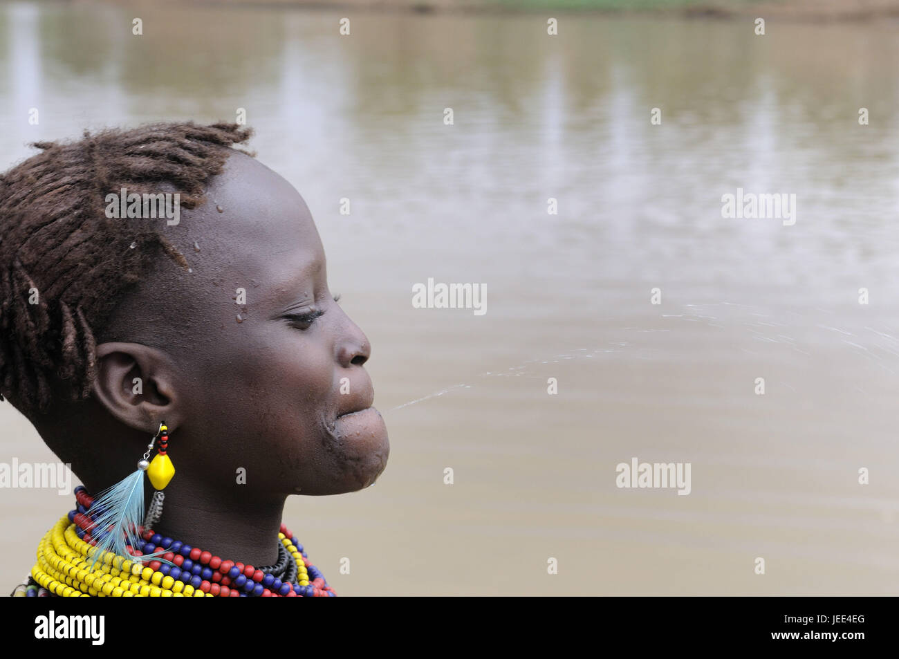 Woman, young, tribe Oromote, water spit, lip, southern Omotal, south ...