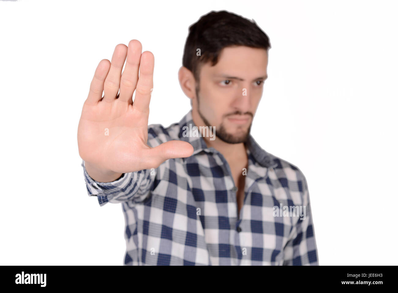Young man doing stop gesture with hand. Isolated white background Stock ...