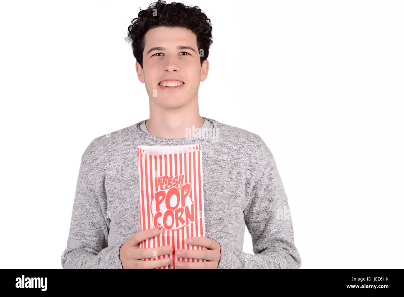 Portrait of young man eating popcorn. Isolated white background Stock ...