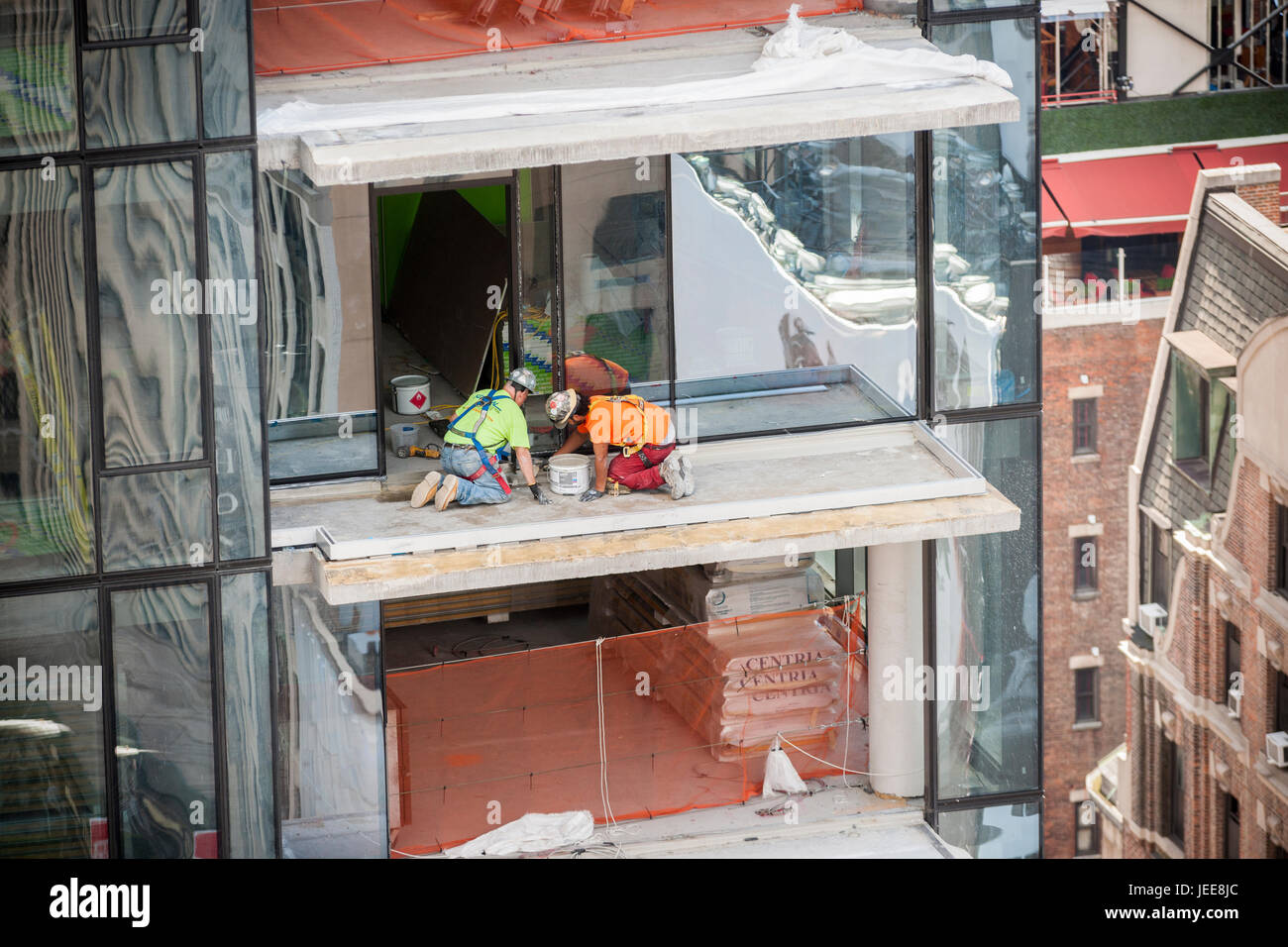 Construction workers on the balcony of an unfinished development in ...