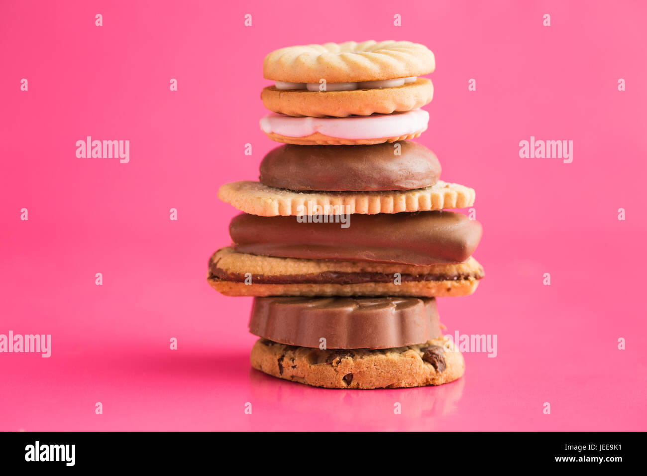 Various sweet biscuits on pink background Stock Photo - Alamy