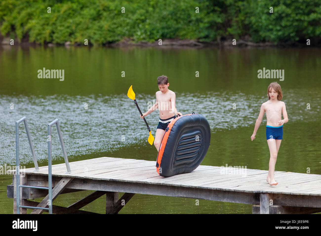 Two Boys Having Fun with Inflatable Rubber Boat in Summer Stock Photo ...
