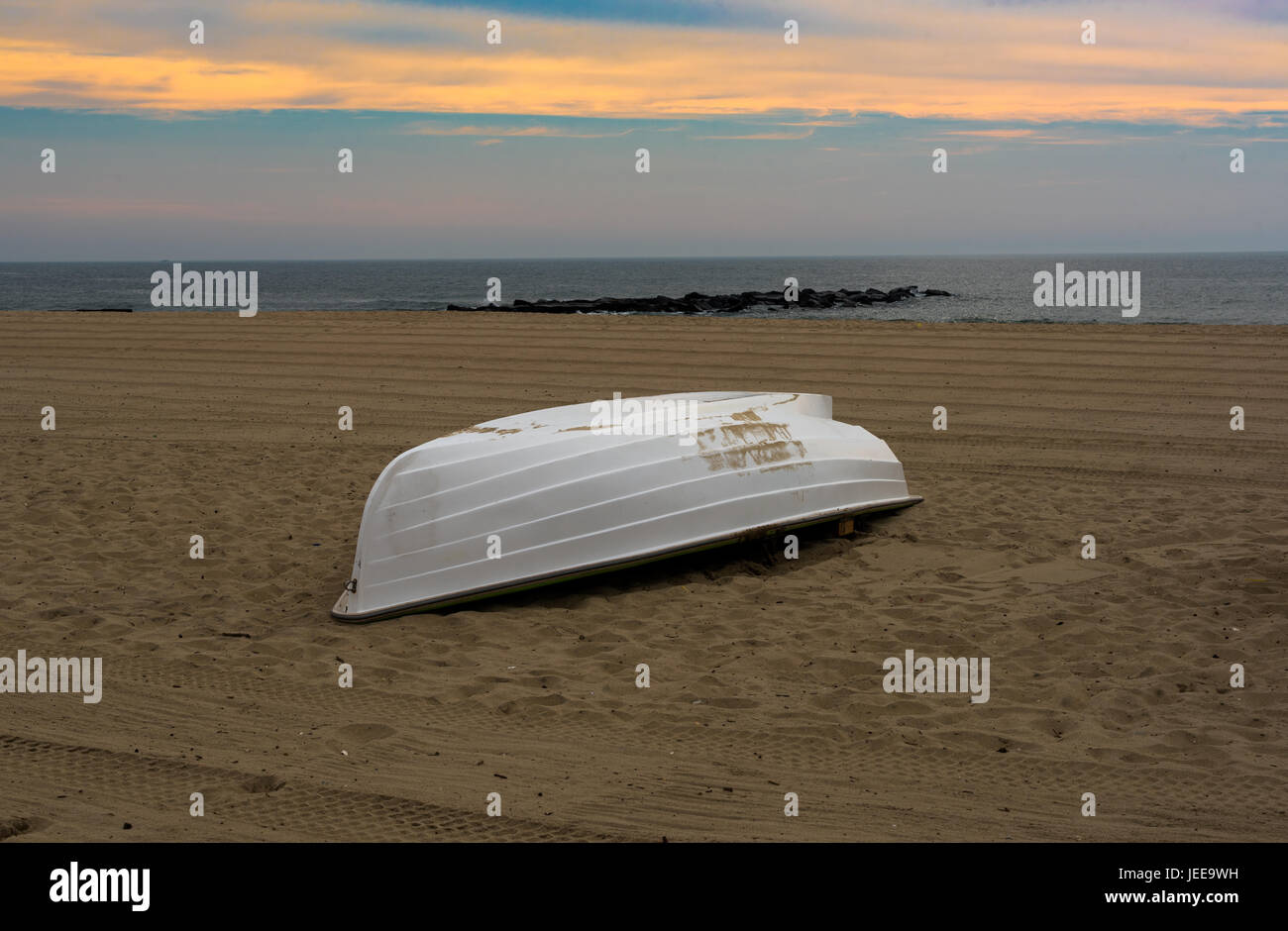 A solitary life boat on the beach early in golden light of morning ...
