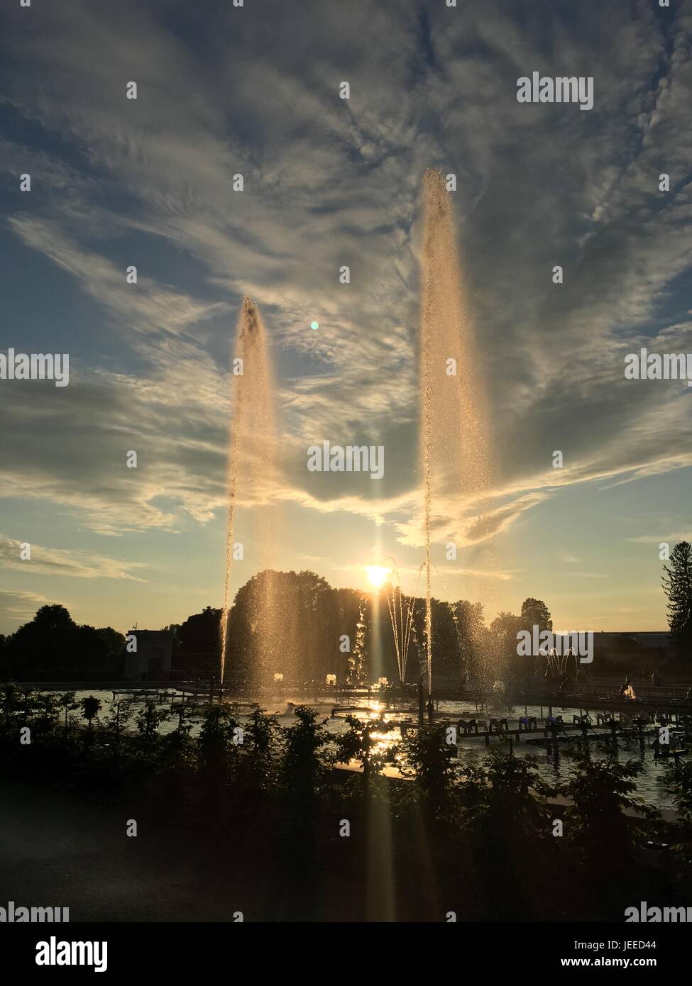Water fountains in the sunset Stock Photo - Alamy